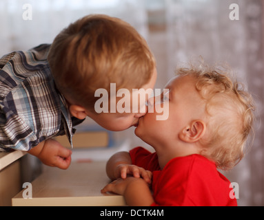 Two little happy brothers kissing outdoors Stock Photo - Alamy