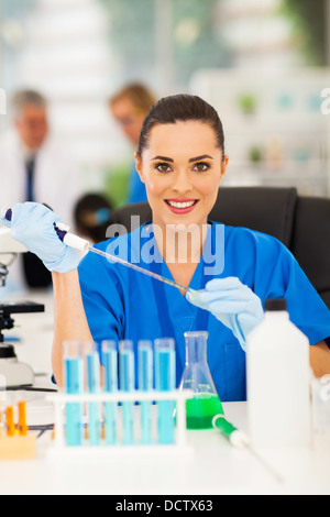 Portrait of a chemist holding a tube with liquid Stock Photo - Alamy