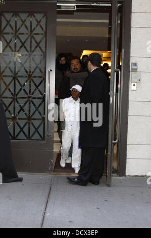 Madonna's adopted son David Banda plays with a home made guitar during ...
