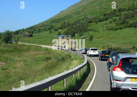 A queue of traffic behind a slow moving vehicle tractor on the A75 road ...