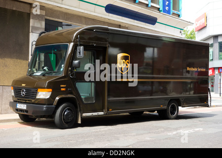 UPS parcels delivery van with driver carrying a large parcel Stock ...