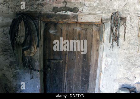 Antique tools hanging on a farm shop wall Stock Photo - Alamy