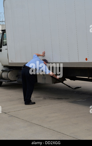 Officer searching vehicle about to enter an American maximum security ...