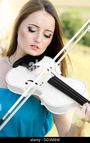 Woman playing violin on white Stock Photo - Alamy