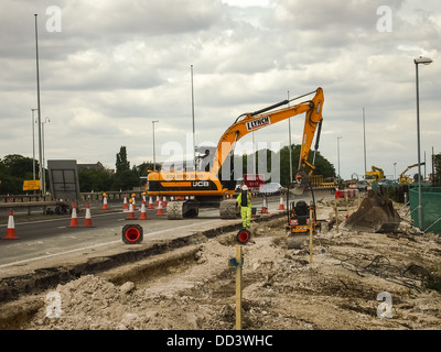 JCB Digger excavator digging trench for field drainage pipes Stock ...