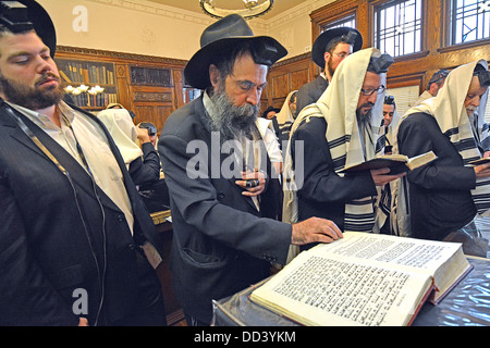 Religious Jews pray in the Rebbe's study at Lubavitch Headquarters in ...