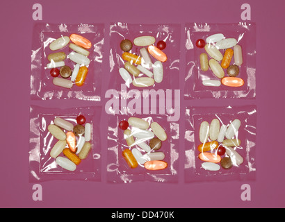 A plastic clear packets of vitamin supplements - pills, capsules and ...