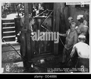 This photograph shows the USS Arizona on fire after the Japanese attack ...