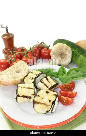 stuffed courgette rolls and tomatoes on a white plate Stock Photo - Alamy
