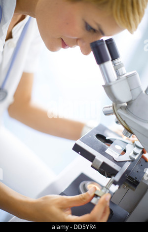 close-up of female scientist analysing samples collected from a ...