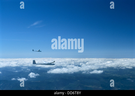 Two glider planes Duo Discus flying over clouds in wave flight near ...
