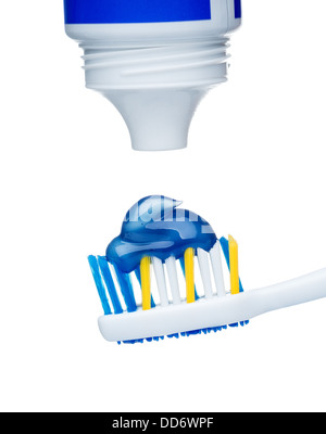 A tube of toothpaste, white and blue striped toothpaste on an orange ...
