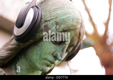 Germany, Cologne, Angel statue with headphones in cemetery Stock Photo ...