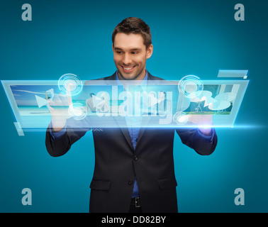 Pressing buttons. A handsome young businessman pointing at copyspace ...