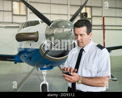 Pilot Using Cell Phone In Cockpit Stock Photo - Alamy