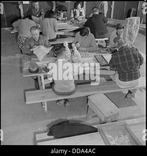 This image shows a wood carving class at the Rohwer Relocation Center ...