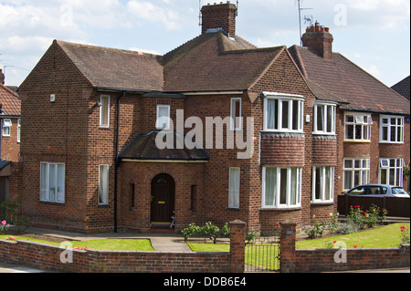 front garden of a large detached house with red gravel driveway and ...