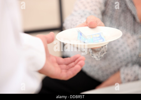 Customer handing over bill to waiter at outdoor restaraunt Stock Photo ...