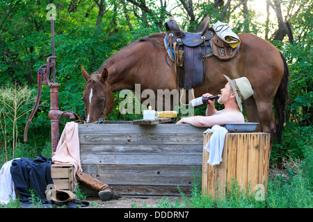 Cowboy drinking whiskey from the bottle Stock Photo - Alamy