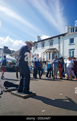 A musician entertains the crowds during Sidmouth Folk Festival, Devon ...