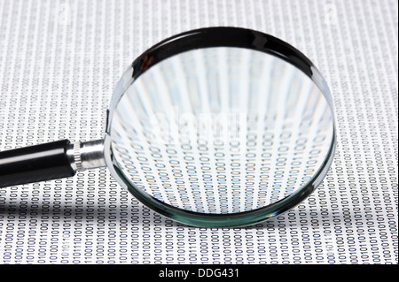 magnifying glass on the background of a binary code Stock Photo - Alamy