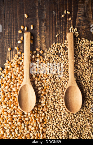 Wood spoons and cereal grains on wooden table Stock Photo - Alamy