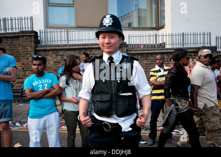 Friendly Asian police officer smiling London Stock Photo - Alamy