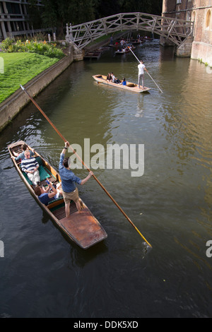 A traditional punt glides along the River Cam beside one of the ...