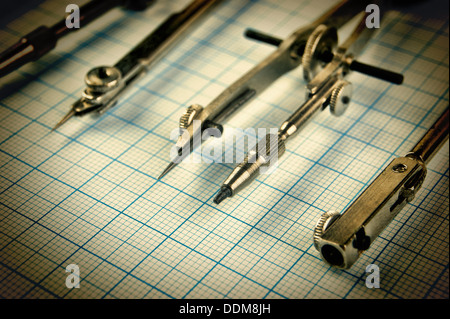 Old drawing tools on graph paper Stock Photo - Alamy
