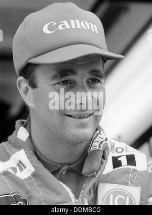 Formula One driver Nigel Mansell shows off his OBE outside Buckingham ...