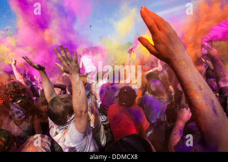 Crowd throwing bright colored powder paint in the air, The Color Run ...