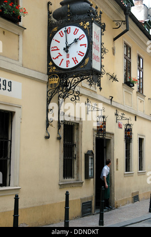 A large retro design clock on the wall at the entrance to U Fleku ...
