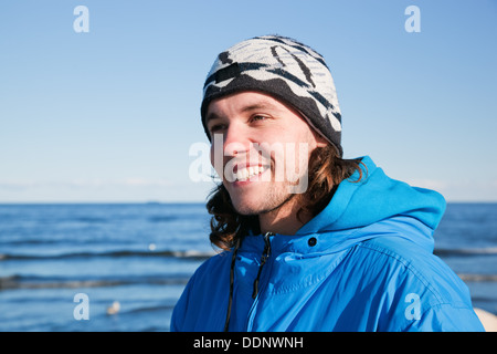 Young handsome man wearing winter sweater over isolated background ...