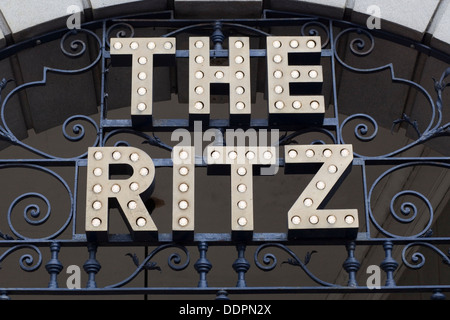The Ritz London hotel sign above walkway with stone engraved mans head ...