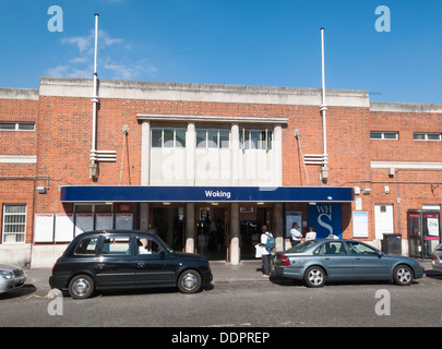 Woking railway station with taxis lined up outside at the taxi rank, on ...