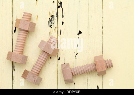Wooden nuts and bolts on table Stock Photo - Alamy