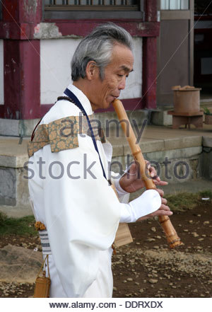 A buddhist monk playing a Japanese bamboo flute (shakuhachi) at a Stock ...