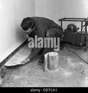 Installing a damp proof course in a house in Goldthorpe, South ...