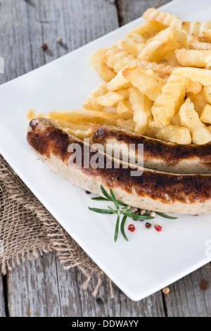Original German Bratwurst with portion of French Fries Stock Photo - Alamy