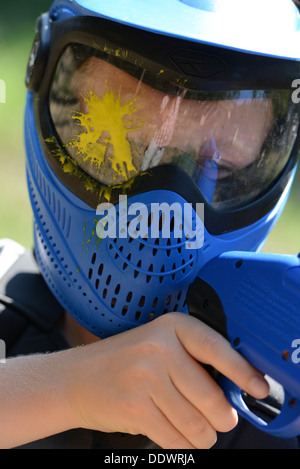 Young children playing paintball in the woods Stock Photo - Alamy