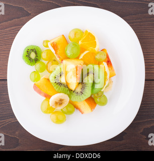 Assortment of sliced fruits on plate Stock Photo - Alamy