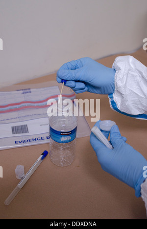 A CSI (Crime Scene Investigator) swabbing a forensic marker on a bike ...