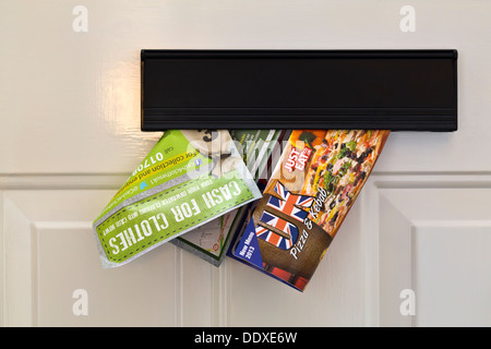 Leaflets through letterbox Stock Photo - Alamy