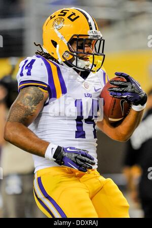 LSU Tigers running back Terrence Magee (18) drops the ball after he is ...