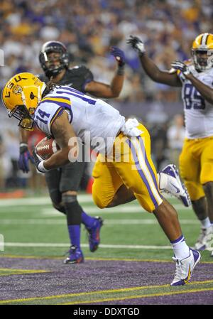LSU Tigers running back Terrence Magee (18) drops the ball after he is ...
