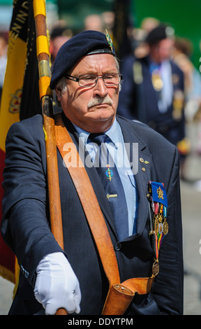 A World War 2 veteran marches behind a band in the Grote Markt, Bruges ...
