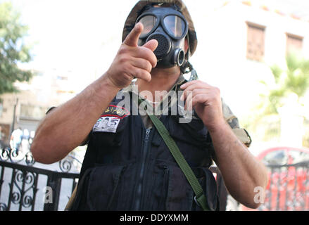 A soldier of the Syrian Arab Army is wearing a gas mask on September 09 ...