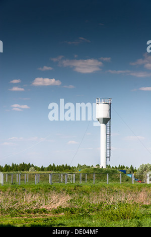 A white watertower against blue sky Stock Photo - Alamy