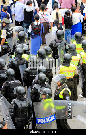 Riot police in full combat gear on standby in the town plaza during ...