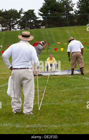 Athletics, official measuring shot put throw distance Stock Photo ...